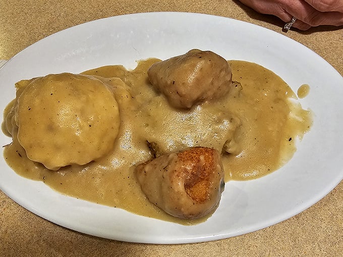 Chicken croquettes swimming in savory gravy—the kind of dish your grandmother would approve of and secretly wish she'd made.
