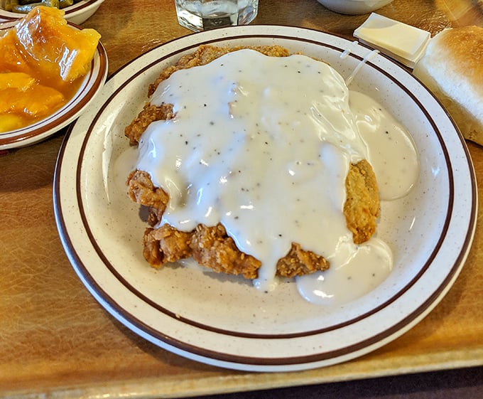 Chicken fried steak swimming in creamy gravy—the Texas state dish that's worth every extra minute on the treadmill tomorrow.