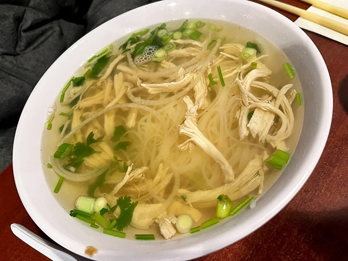 A bowl of chicken noodle soup that could make your grandmother nervous about her family recipe ranking. Clear broth, tender chicken, and noodles that know their place.