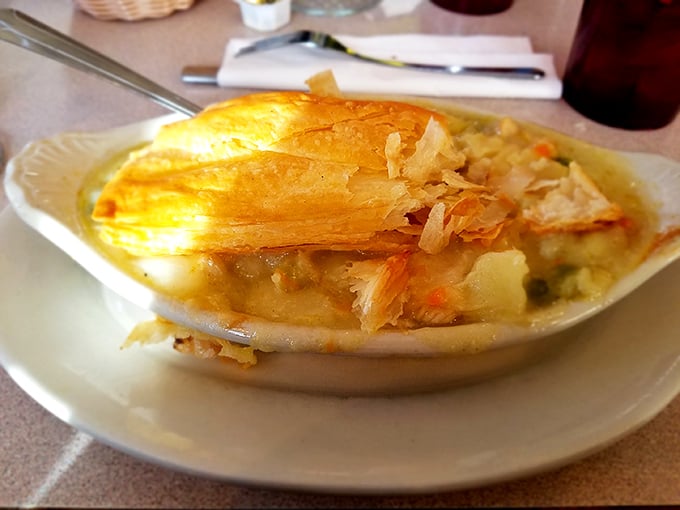 This chicken pot pie isn't just comfort food—it's a warm hug on a plate, with flaky pastry revealing a steamy treasure of chicken and vegetables.