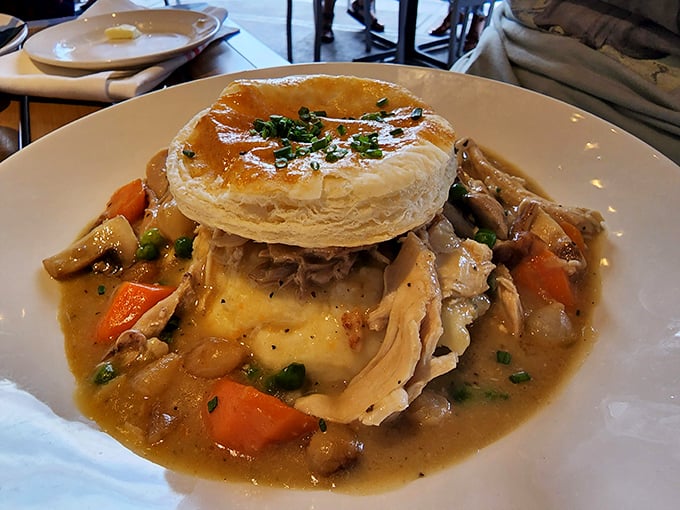 Not your average pot pie—this towering creation with its golden pastry crown shelters a savory kingdom of tender chicken and vegetables.