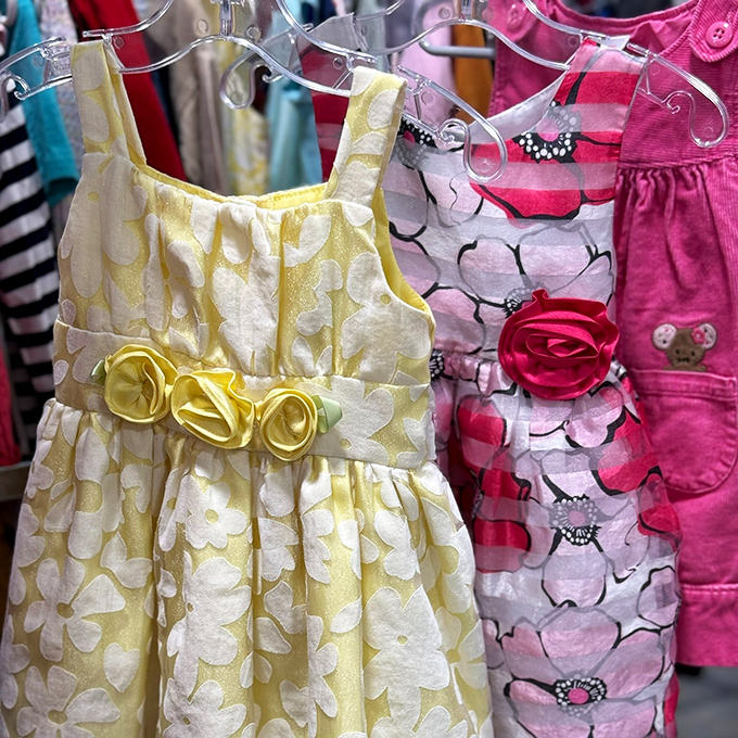 Tiny formal wear with big personality! These sunshine-yellow and floral dresses await special occasions and inevitable ice cream stains.