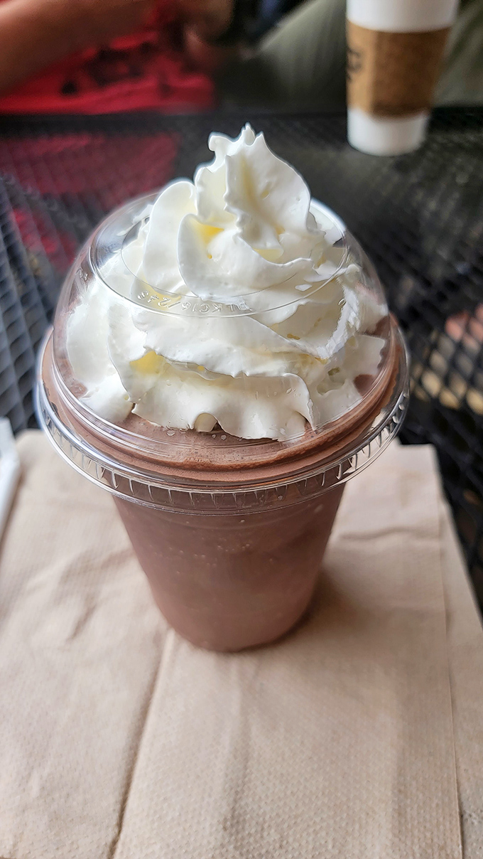This isn't just a chocolate shake—it's a tower of whipped cream atop a chocolate foundation that makes you question why anyone would ever drink plain milk.