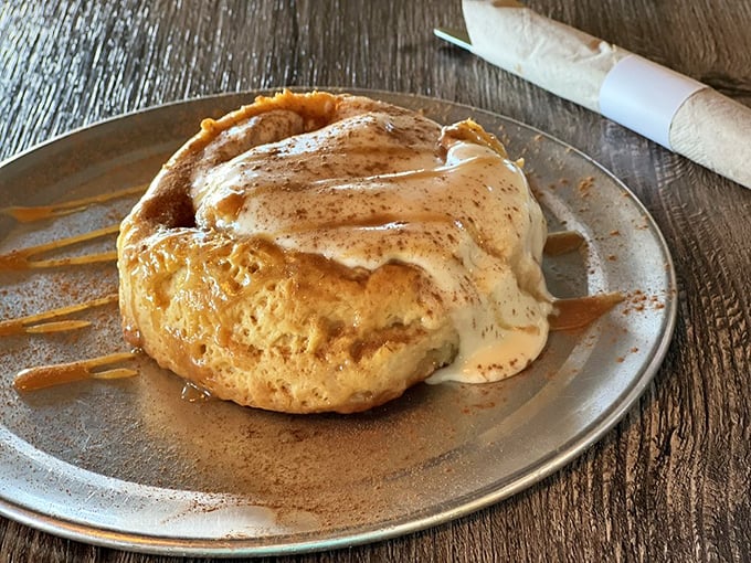 This isn't just a cinnamon roll—it's a warm hug on a plate, complete with cream cheese frosting that melts into every nook and cranny.