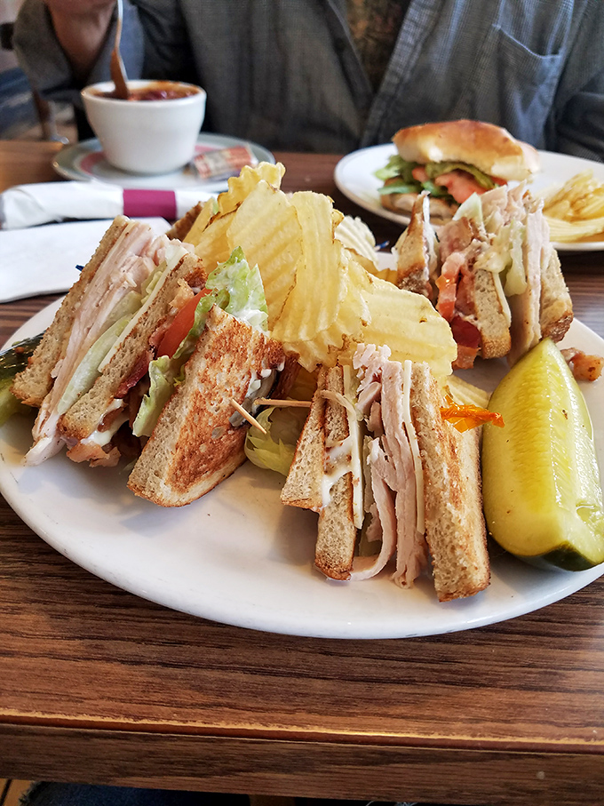 The club sandwich – architecture you can eat. Three stories of turkey, bacon, and toast that requires an engineering degree to disassemble properly.