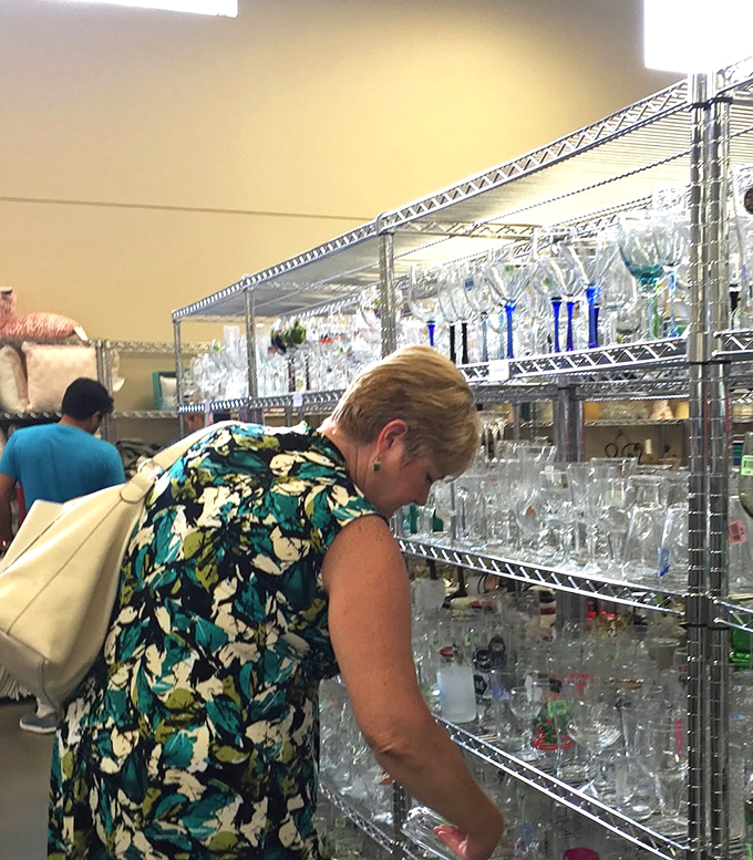 The glassware aisle—where serious hunters examine each piece with the focus of a diamond appraiser at Tiffany's.