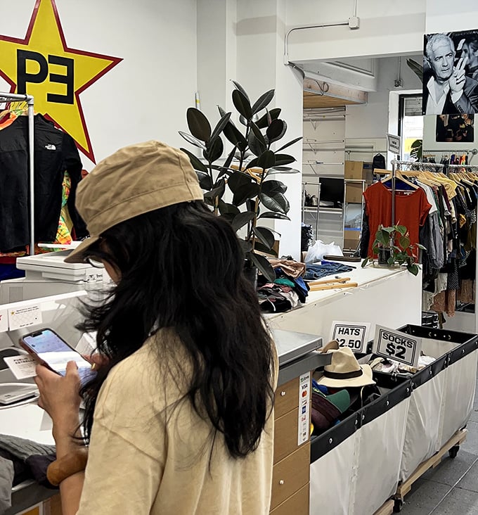 A shopper deep in the treasure-hunting zone. That focused expression is universal—it's the look of someone who just spotted vintage Armani.