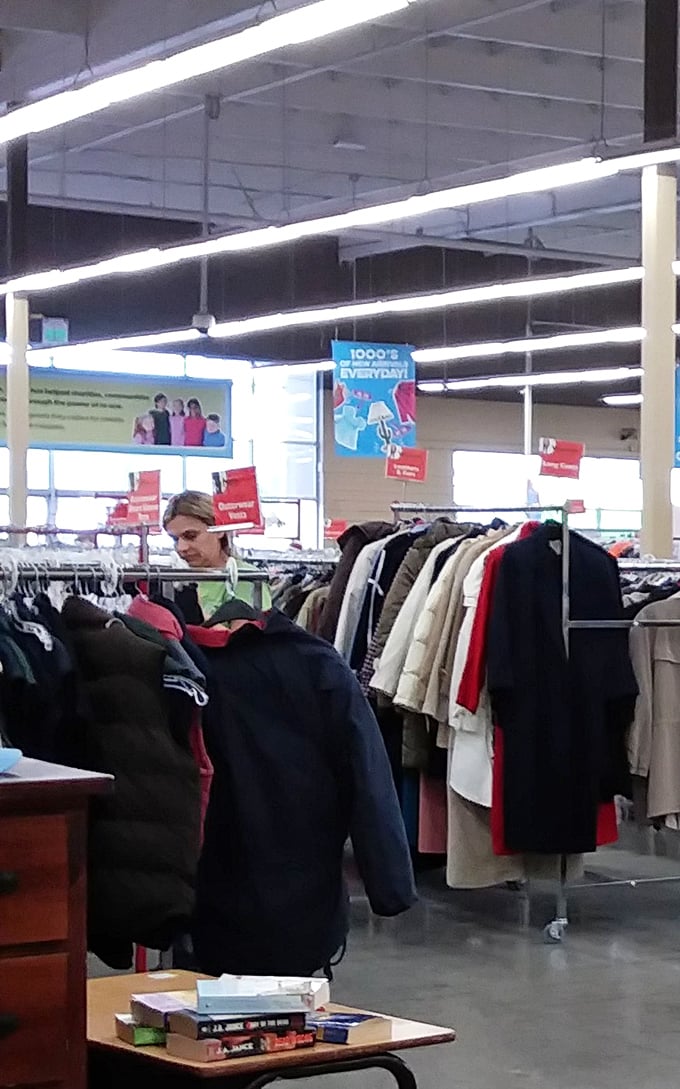 The clothing aisles—where fashion trends of decades past patiently wait for their inevitable comeback, and shoppers hunt with focused determination.