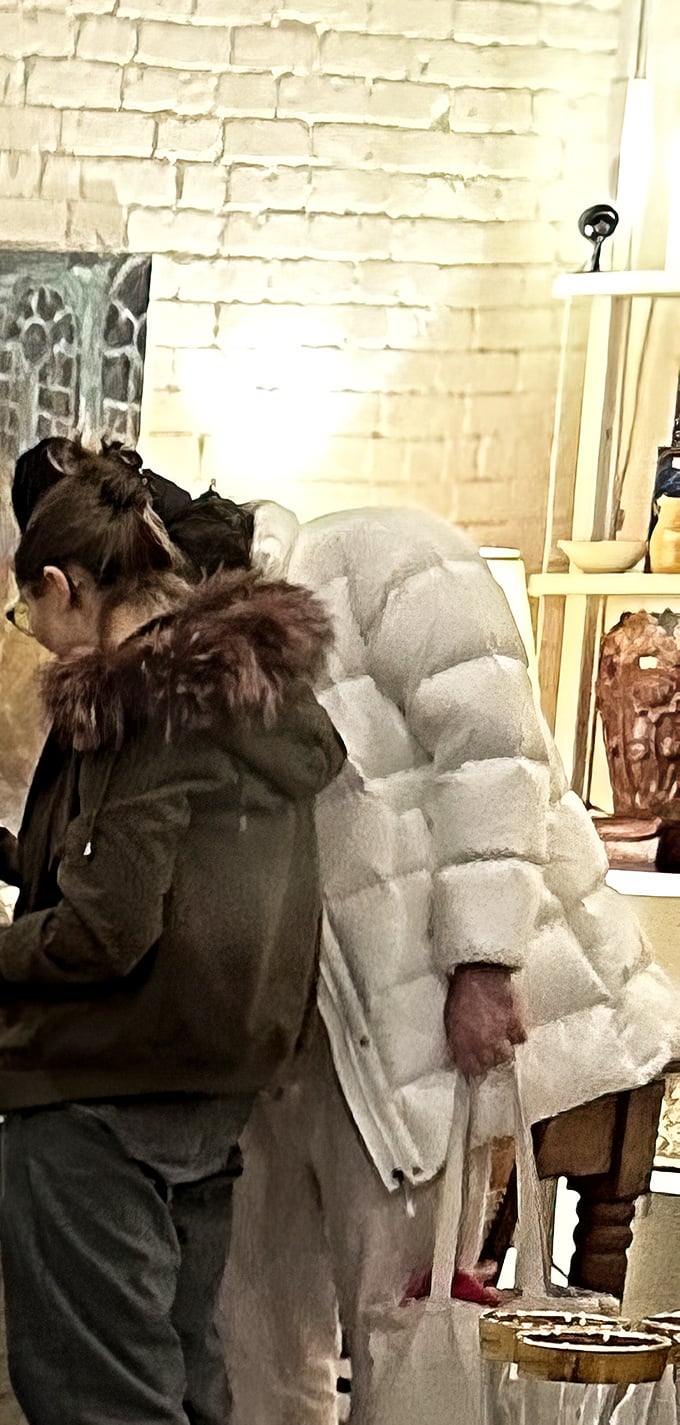 Treasure hunters examine unique finds against the store's signature white brick walls—the thrill of discovery is palpable.
