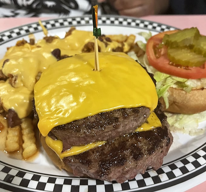 Behold the double cheeseburger in its natural habitat—draped in melted American cheese like a yellow security blanket for your taste buds.