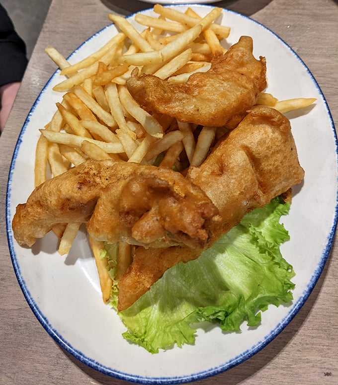 Fish and chips that would make a British pub jealous, with a crispy golden batter that shatters with each bite.