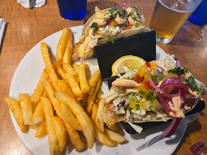 These fish tacos aren't just a meal; they're edible postcards from the Gulf, complete with crispy fries as their traveling companions.