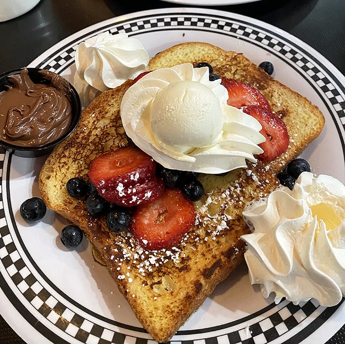 French toast that's dressed for success with berries, cream, and enough visual appeal to make you temporarily forget your diet resolutions.