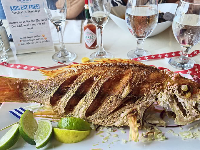 This whole fried fish isn't just dinner—it's performance art with fins, served with a supporting cast of citrus.