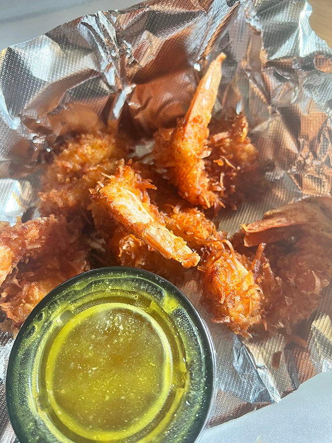 Golden-battered shrimp that crunch like autumn leaves, paired with melted butter that transforms each bite into a coastal revelation.