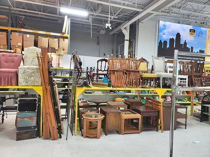 The furniture section resembles a wooden United Nations—mid-century modern chairs diplomatically sharing space with colonial end tables and that one weird ottoman nobody understands. 