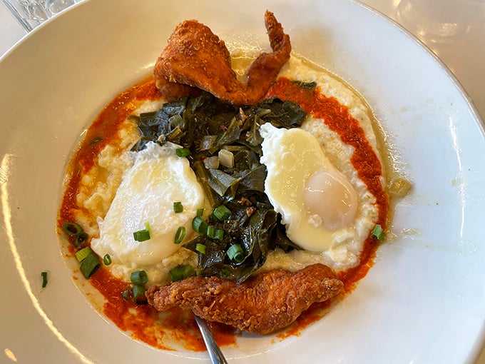 Creamy grits cradle perfectly cooked eggs while collard greens add a touch of Southern soul. The crispy chicken strips aren't just garnish—they're the exclamation point.