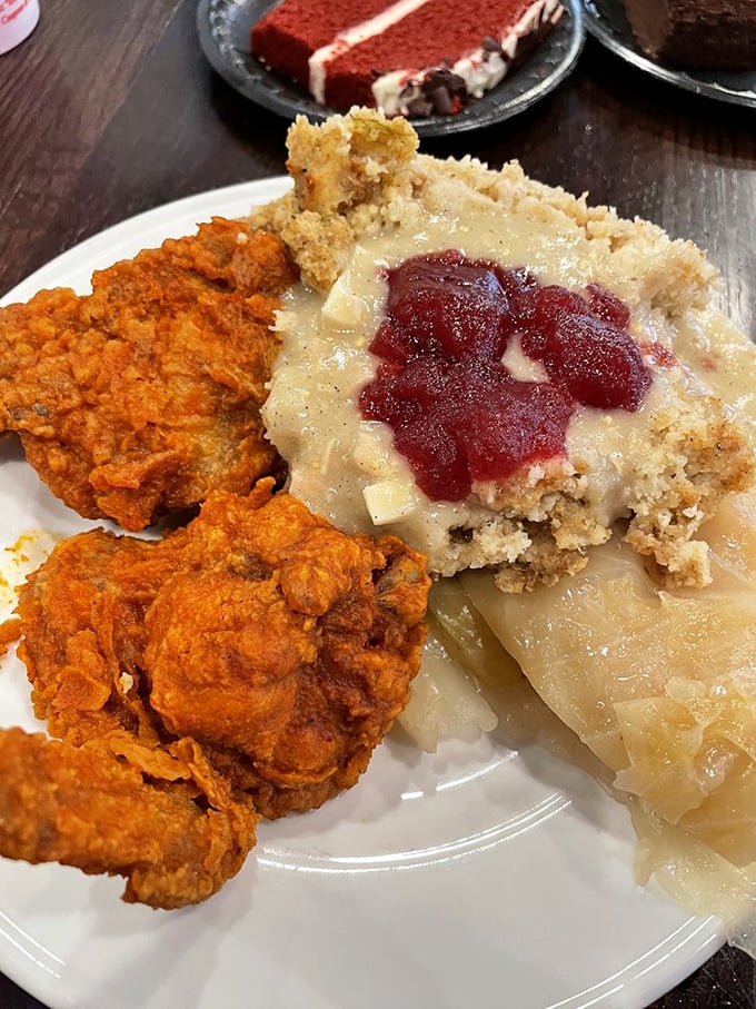 Southern comfort on a plate: golden fried chicken beside apple-topped dressing that would make grandmothers nod in silent, respectful approval.