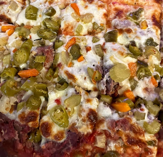 When giardiniera meets melted cheese, magic happens. This pizza doesn't need a passport to Italy—it's pure Illinois comfort in circular form.