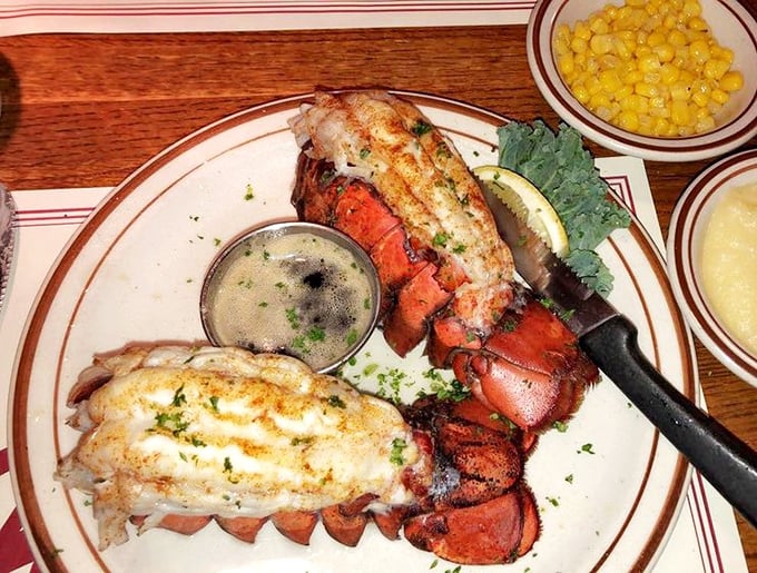 Twin lobster tails presented with military precision, flanked by melted butter – simplicity that speaks volumes about seafood confidence.