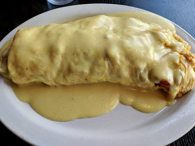 The omelet that launched a thousand food dreams, draped in hollandaise like a silky golden cape for egg superheroes.