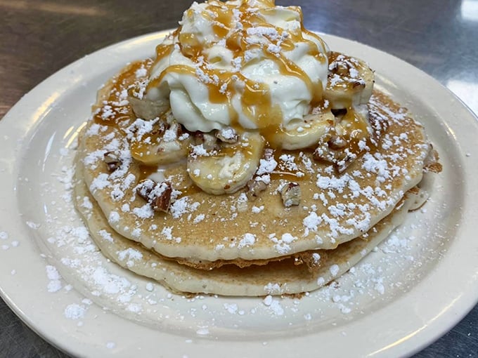 Pancakes crowned with bananas, whipped cream, and caramel – because sometimes breakfast should double as dessert, and nobody's judging here.