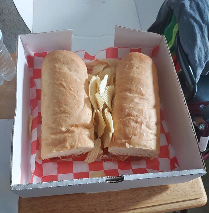 Not all heroes wear capes; some come in bread form. This sandwich isn't just lunch—it's an architectural marvel of carbs and chips. 