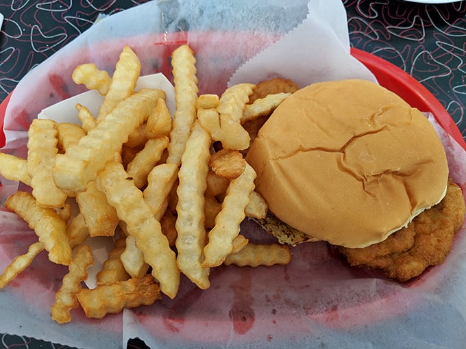 The pork tenderloin sandwich arrives with crinkle-cut fries that make you wonder why anyone bothers with straight ones.