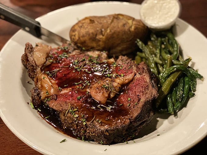 This prime rib isn't just dinner – it's a carnivore's sonnet, with that rosy center and herb-flecked crust playing perfect harmony with those vibrant green beans.