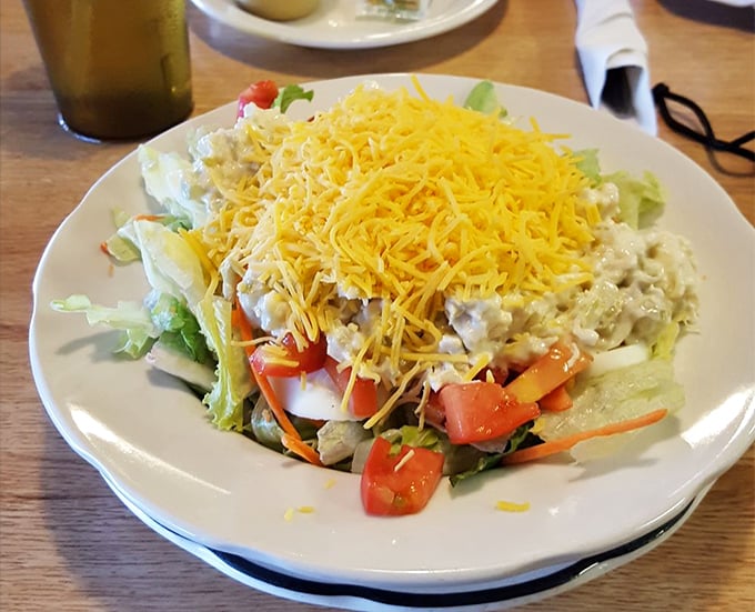 This isn't just a salad—it's a colorful landscape of fresh vegetables crowned with a sunshine-yellow mountain of shredded cheddar.