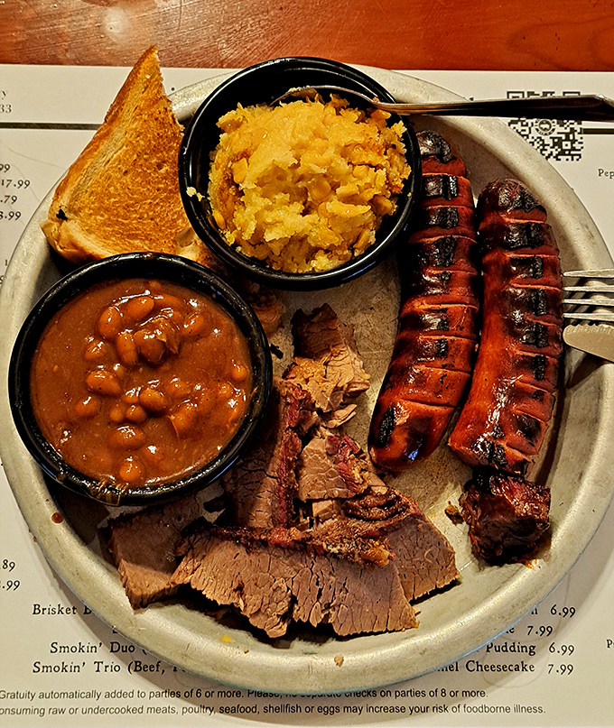 This plate tells a story of patience—sliced brisket with that telltale pink smoke ring, sausage with perfect snap, and sides that refuse to be mere afterthoughts.