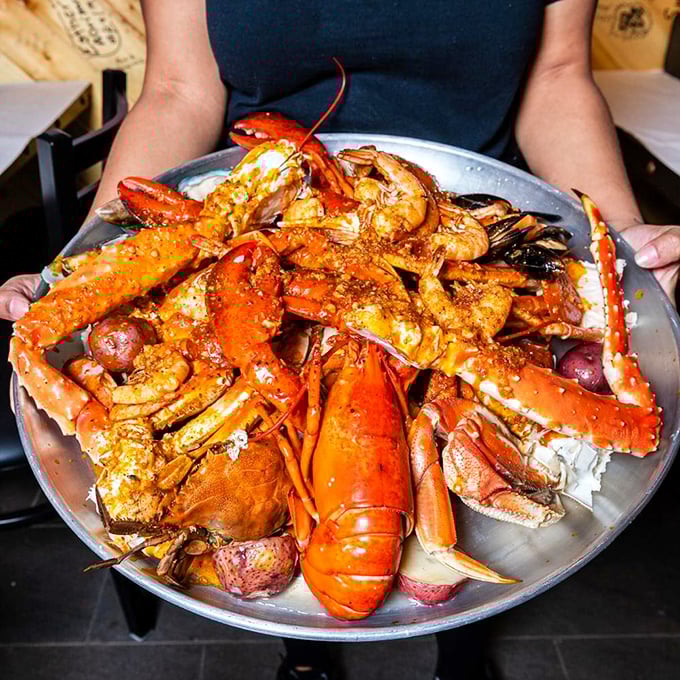 Not so much a meal as a glorious seafood battlefield—lobster, crab legs, and shrimp seasoned to perfection, awaiting your strategic attack.