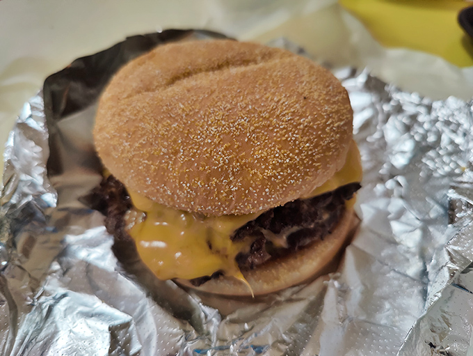 That melted cheese cascading down the burger patty isn't just food—it's edible sunshine on a sesame seed throne.