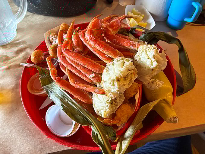 Snow crab legs arranged like a crown jewel, surrounded by corn on the cob—proof that sometimes the best dining experiences require a little manual labor.