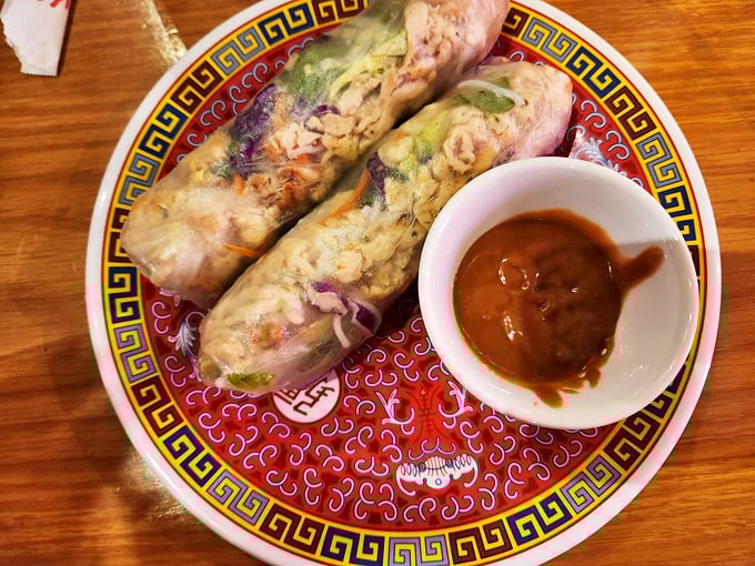 Fresh spring rolls that haven't been sitting around getting tough—translucent rice paper revealing colorful vegetables like edible gifts.