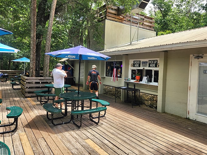 The Spring Side Grill: where picnic tables under blue umbrellas promise a meal with a side of serenity.