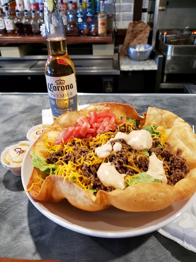 The legendary taco salad in all its glory—a crispy tortilla fortress protecting a kingdom of seasoned beef, cheese, and fresh veggies.