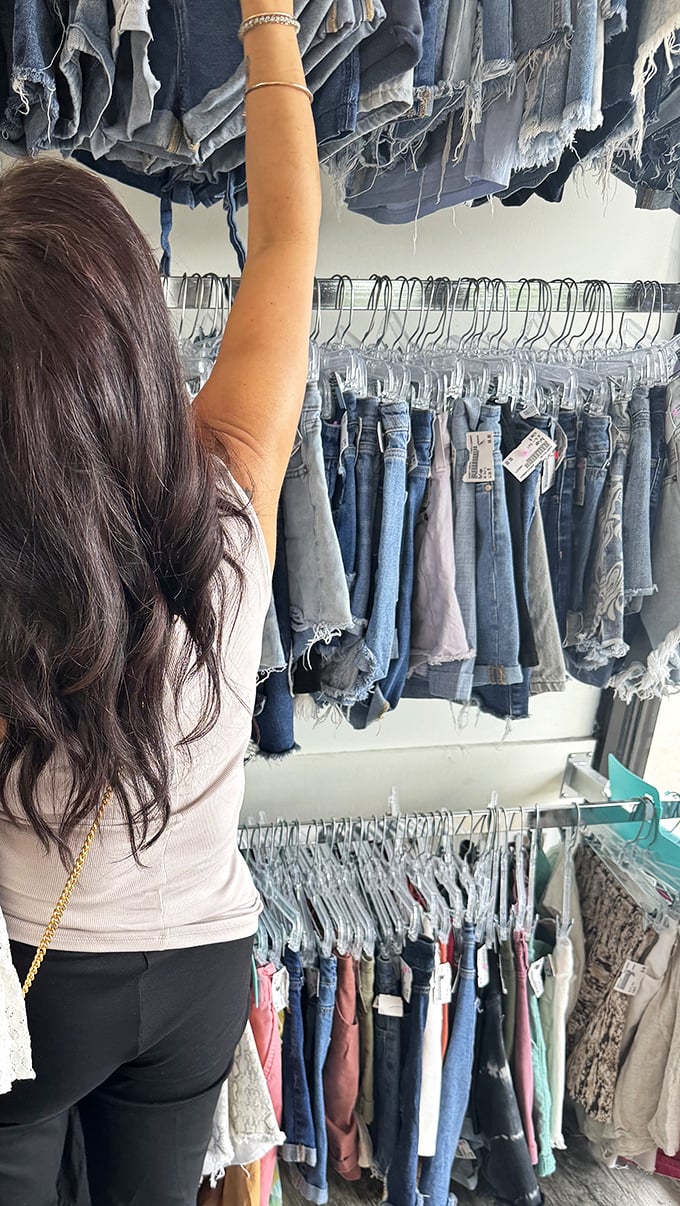 The thrill of the hunt captured in action – reaching for that perfect pair of jeans feels like striking fashion gold.