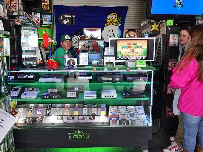 Gaming paradise where retro meets modern. That gleaming display case houses the digital ancestors of today's PlayStation—the original Nintendo and SNES consoles that raised generations.