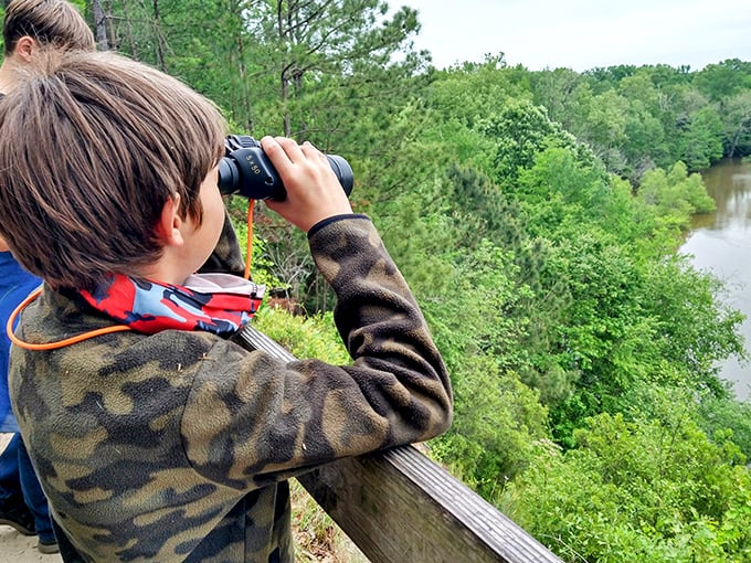 Young explorers discover the joy of wildlife watching—binoculars turning an ordinary hike into a National Geographic expedition.