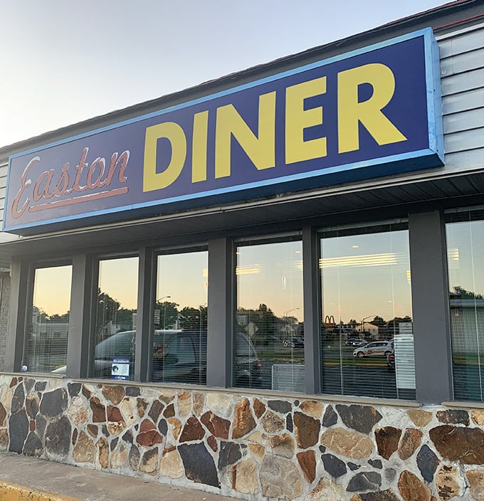 Easton Diner's bold blue and yellow sign pops against the stone foundation – Eastern Shore dining with character and charm.