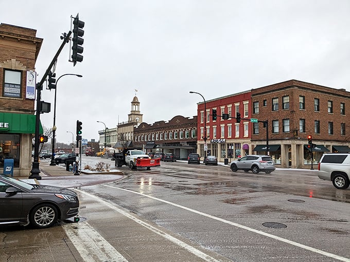 Snowplows and storefronts create winter's ballet! Geneva's intersection captures that perfect moment between storm and calm, like nature's own intermission.
