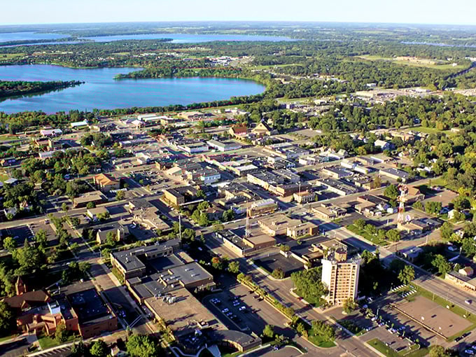 An aerial view of Grand Rapids shows a vibrant downtown surrounded by lakes and greenery, blending small-town charm with scenic views.