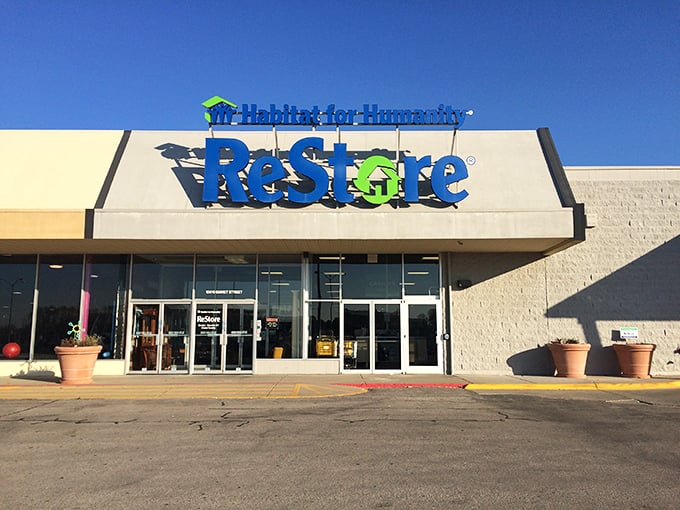 The ReStore's bright blue sign stands out against the clear Nebraska sky—a beacon for DIY enthusiasts and bargain hunters.