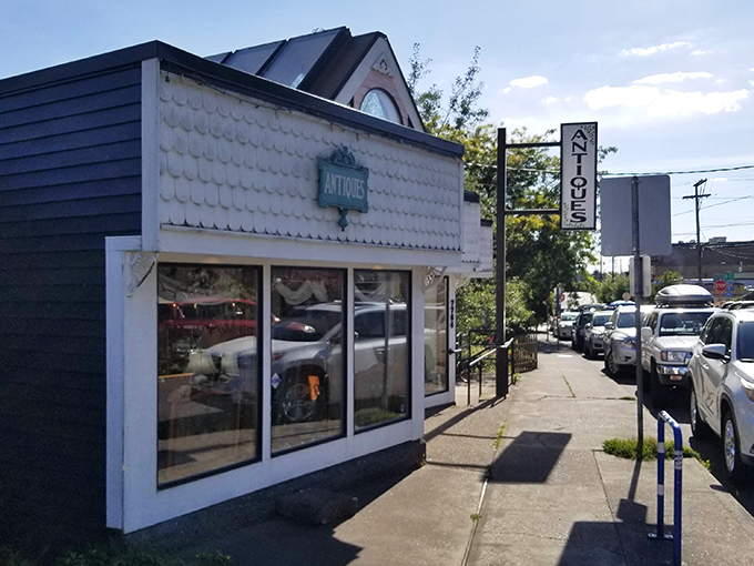 Classic white siding and a simple sign mark this Portland gem – like finding a secret clubhouse for vintage enthusiasts.