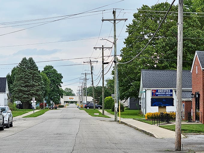 Power line parade! Orestes' main drag showcases small-town living where church announcements and neighborly waves are the social media of choice in this digital detox paradise.