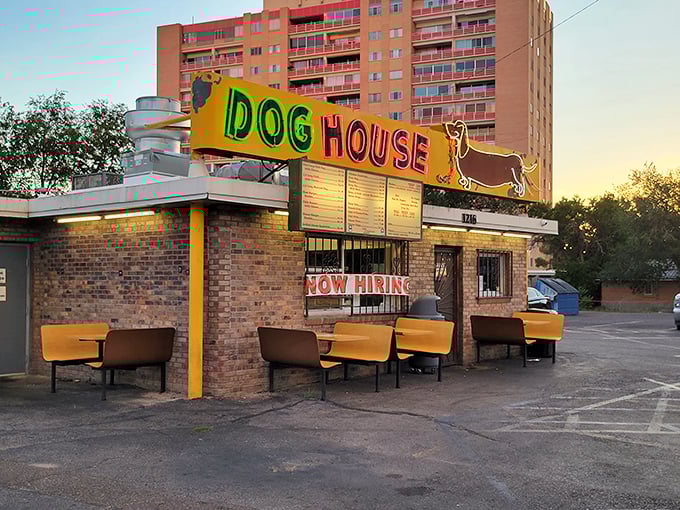 The Dog House's neon wiener dog sign glows at dusk—proof that great breakfast spots don't need fancy facades.