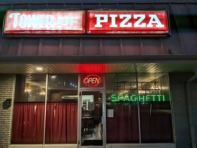 Tower of Pizza's vintage sign and red curtains transport you back to when disco was king and pizza was queen.
