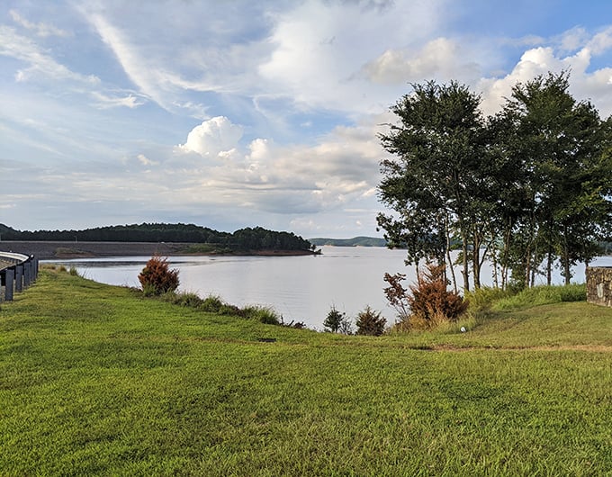 Broken Bow Lake stretches like a blue mirror, reflecting clouds and pine trees in perfect harmony.
