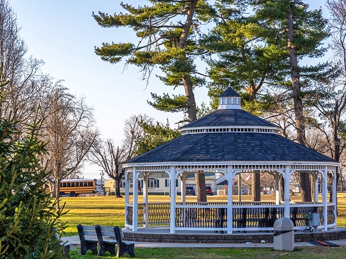 A gazebo straight out of a Norman Rockwell painting—quiet charm, wooden benches, and stories waiting to unfold.